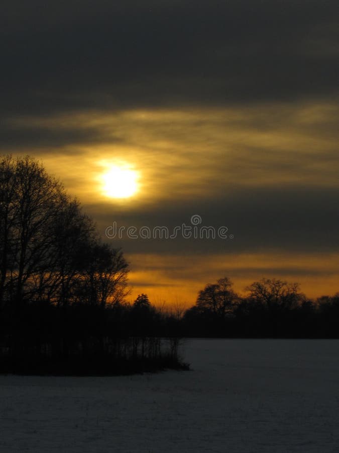 A Cold Sunset stock photo. Image of trees, evening, water - 105799954