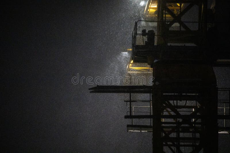 Snow Under the Light of a Construction Crane at Night Stock Image ...