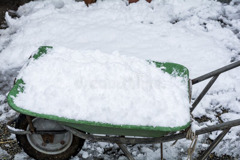 Snow on wheelbarrow stock photo. Image of snow, barrow - 84458682
