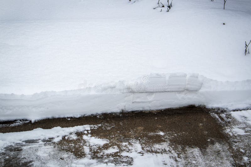 Snow Where a Gate Has Cut it To Show Its Depth and Scraped the Driveway ...