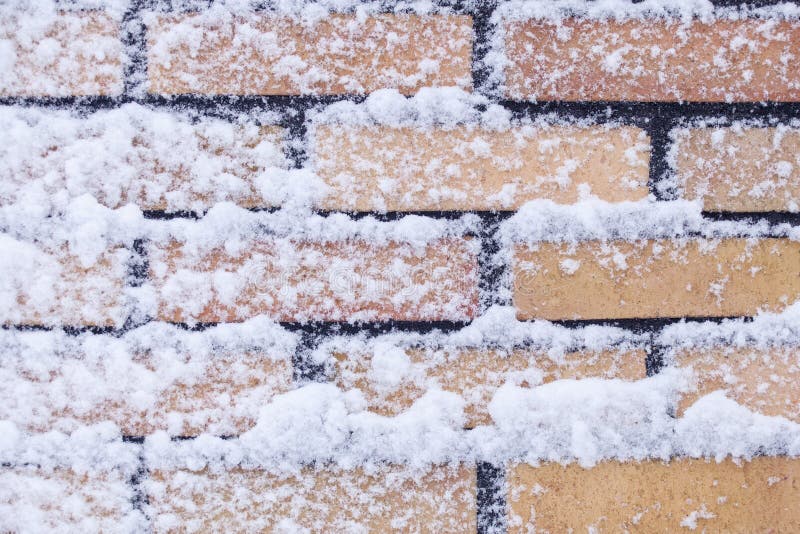 Snow on yellow brick wall stock image. Image of graphic - 203214139