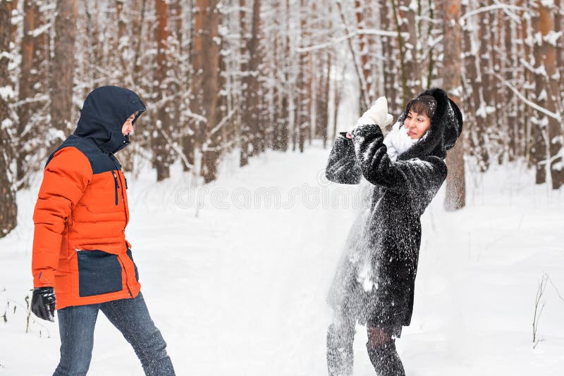 Snowball Fight. Winter Couple Having Fun Playing in Snow Outdoors ...