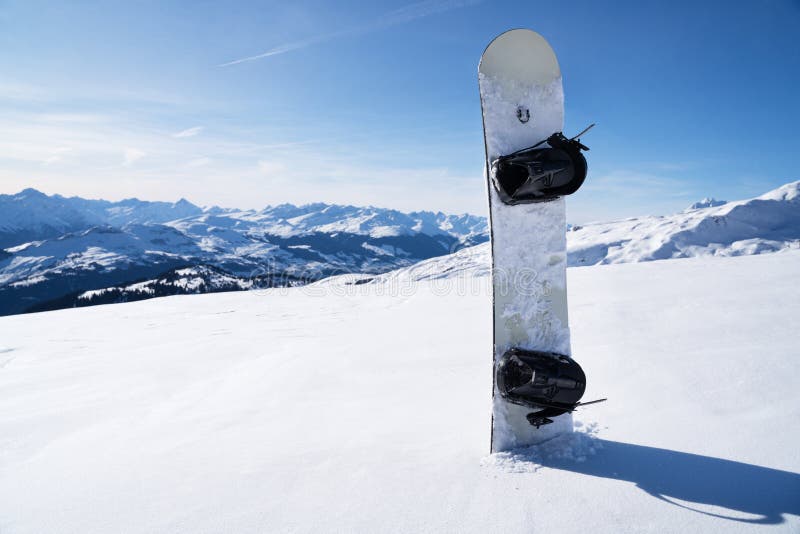 Snowboard Standing in Snow with Winter Mountains in Background Stock ...