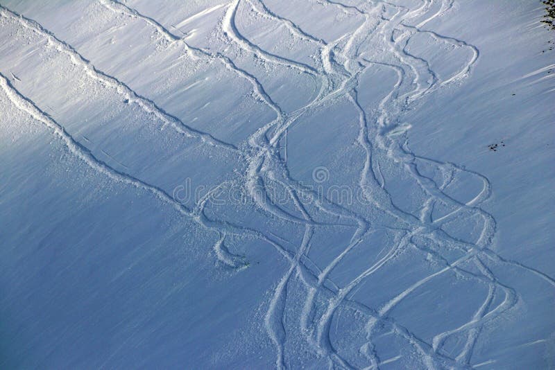 Ski and Snowboard Tracks on a Slope Stock Photo - Image of snow, blue ...