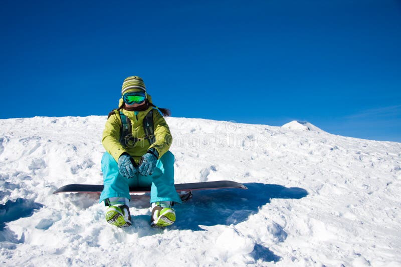 Snowboarder girl sitting stock image. Image of girl, green - 24193109