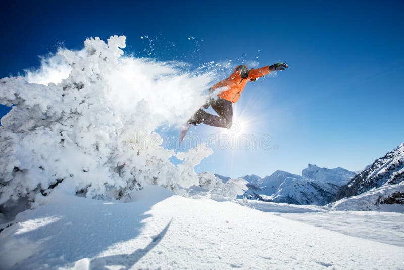 Young Man Snowboarder Running Down the Slope in Alpine Mountains Stock ...