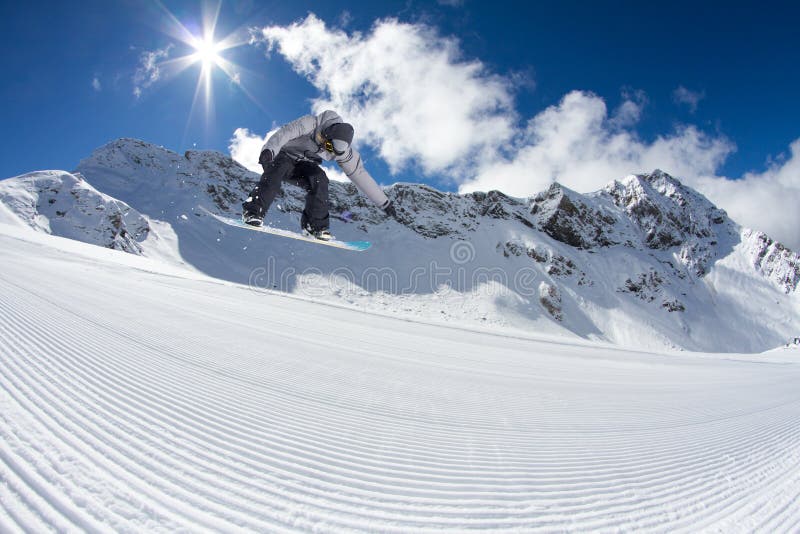 Snowboarder Jumping on Mountains. Extreme Sport. Stock Photo - Image of ...