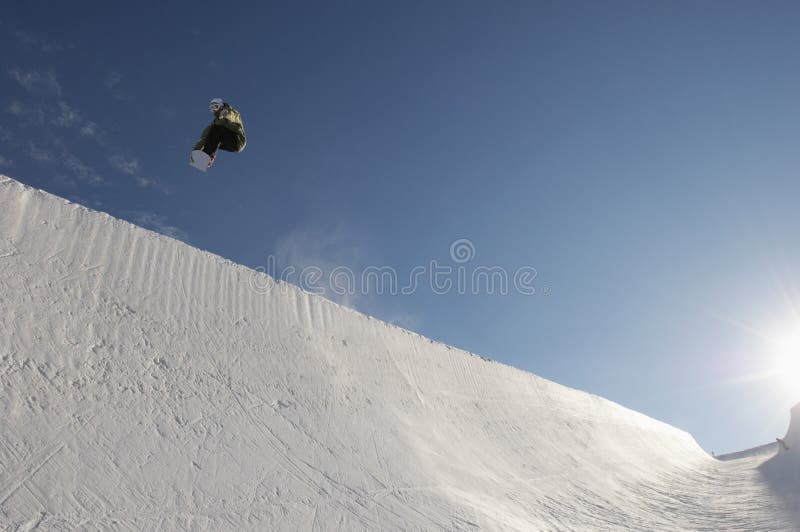 Snowboarder Performing Stunts in Park Against Blue Sky Stock Image ...
