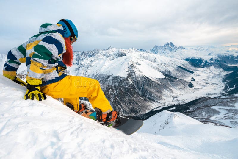 Snowboarder is Sitting on the Mountain and Having a Rest Stock Photo ...