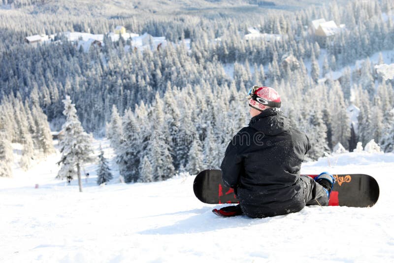 Snowboarder Sitting on a Mountain Slope Stock Image - Image of slope ...