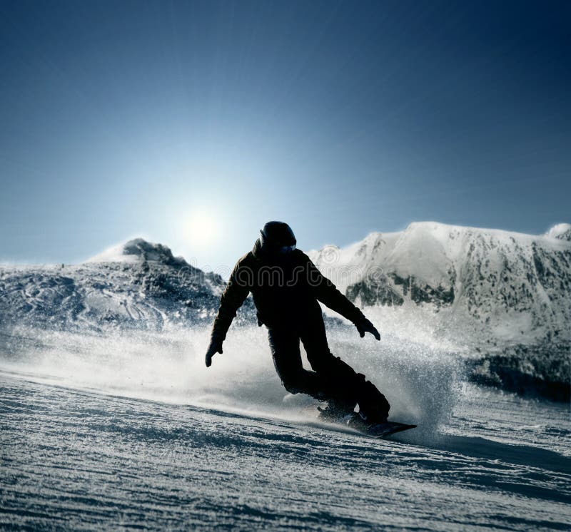 Snowboarder Slides Down Snowy Ski Slope Stock Photo - Image of resort ...