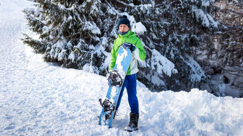 Snowboarder Standing on the Snow and Keeps the Board Stock Image ...
