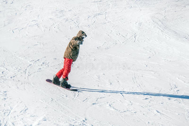 Snowboarding in Red Pants in Mountains on the Background of White Snow ...