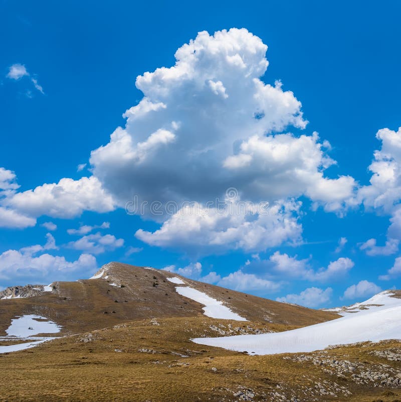 Snowbound Mountain Ridge Under a Dense Cumulus Clouds Stock Image ...