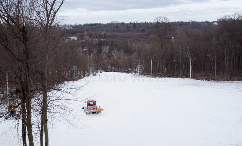 A Small Snowcat in the Parking Lot while Snowing in Alps Switzerland ...