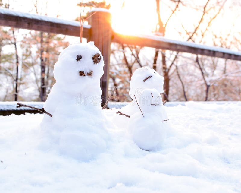 Snowman Family in Park during Sunset Stock Photo - Image of park, organ ...