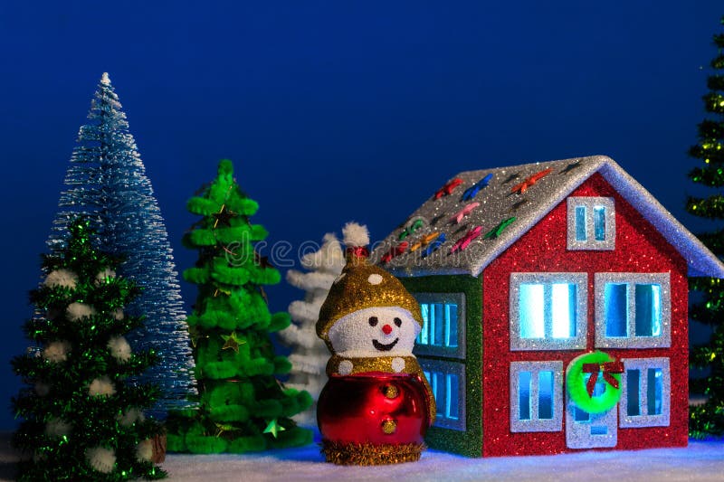 Snowman Near a House with Blue Light in the Windows Stock Photo - Image ...