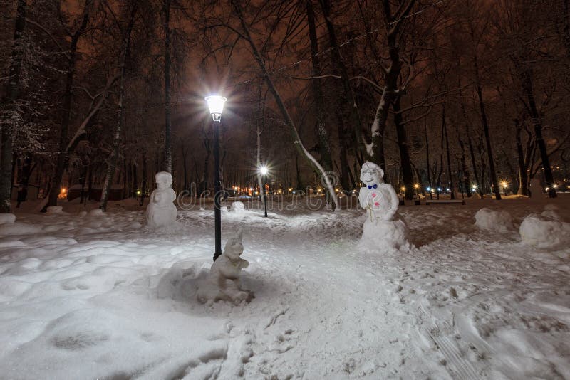 Snowman at night park stock photo. Image of family, beauty - 186863664