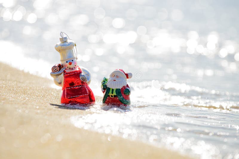 Snowman And Santa Claus On Sea Beach Christmas And New Year`s Vacation