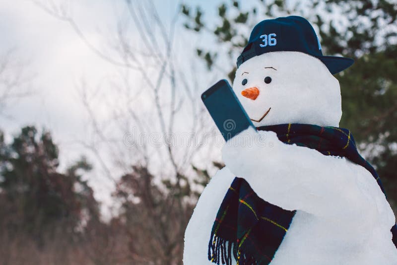 Snowman using smart phone stock photo. Image of person - 160635372