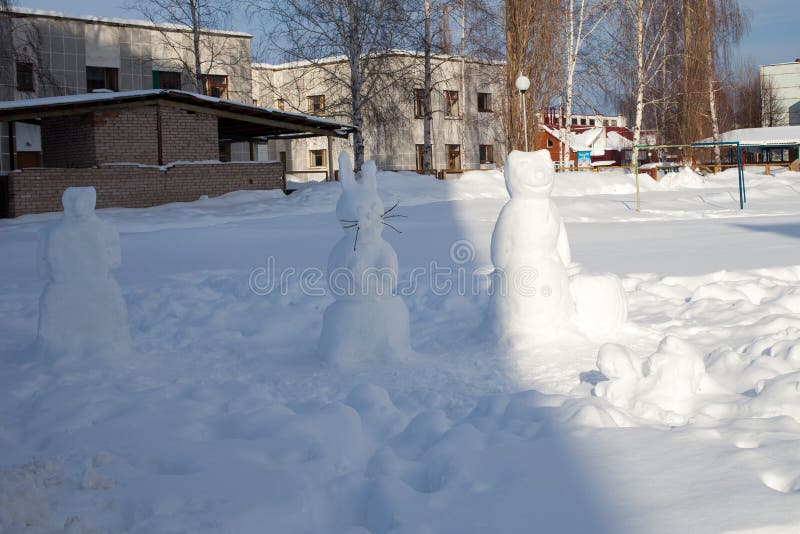 Snowmen in the Courtyard of a Multi-storey Building in Russia. Winter ...