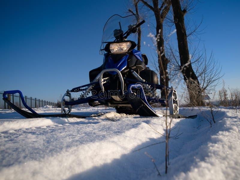 Snowmobile and blue sky stock photo. Image of motorsledge - 14720182