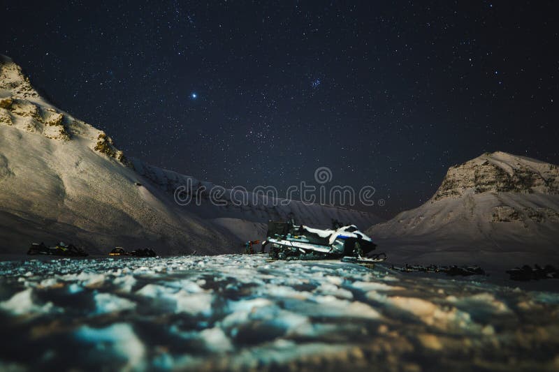 Snowmobile with Mountains Under the Night Sky in Longyearbyen, Svalbard ...
