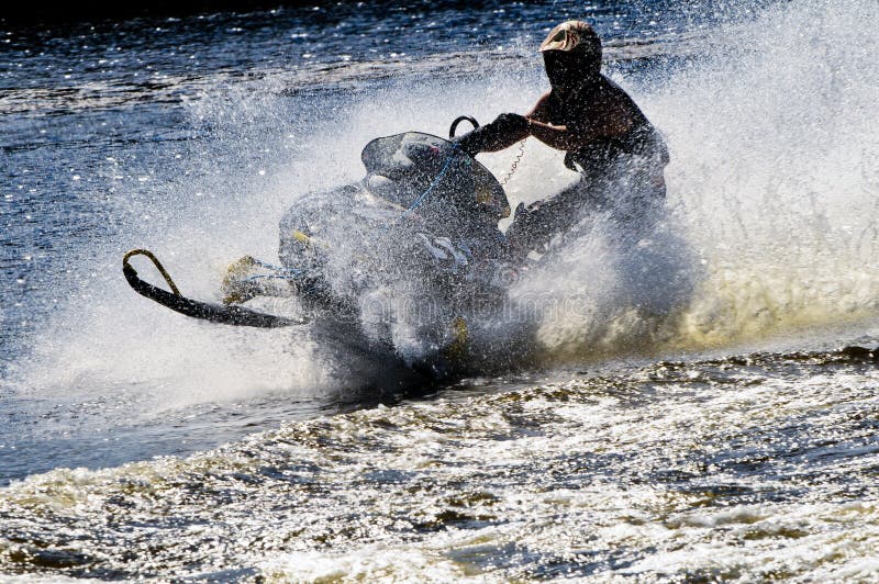 Snowmobile on open water editorial stock photo. Image of season - 6039133