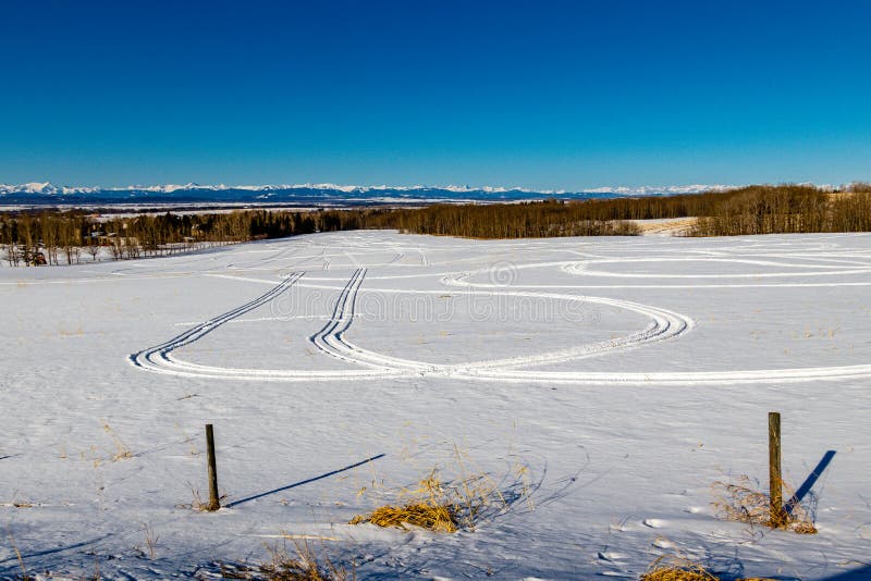 Snowmobile Tracks on Lake in Snow, Boy Standing Stock Image - Image of ...