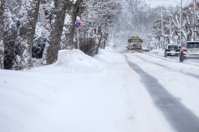 A Snowplow is Coming, Cleaning the Snow after a Heavy Snowfall in a ...