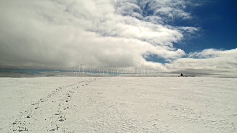 Snowshoe tracks stock image. Image of clouds, footprints - 54829029