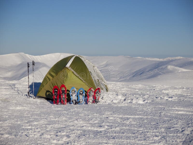 Snowshoes and Tent on Snow in the Mountains. Stock Photo - Image of ...