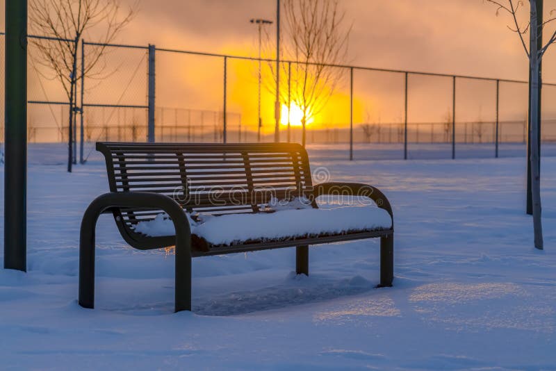 Snowy Bench with Setting Sun in the Background Stock Image - Image of ...