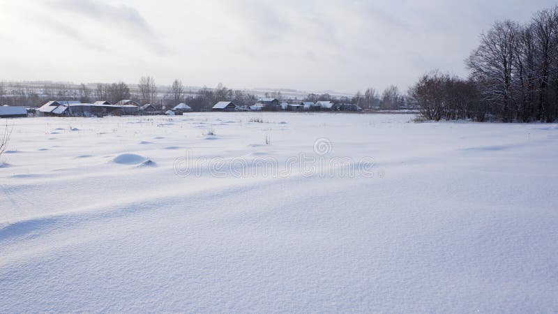 Snowy Field with a Village in the Distance Stock Photo - Image of ...