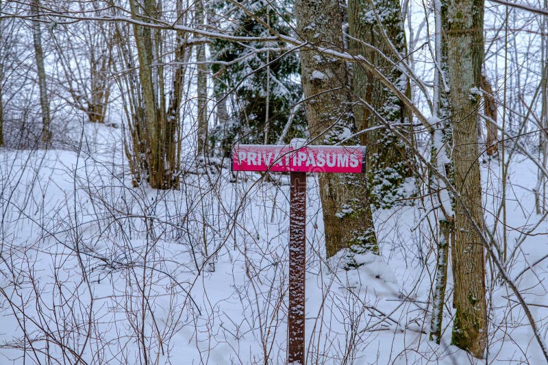 A Snowy Forest with a Red Sign with the Text Private Property Stock ... A Snowy Forest with a Red Sign with the Text Private Property Stock ...