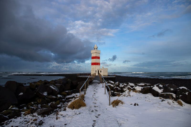 Snowy Landscape with a Lighthouse at the Rocky Coast Stock Photo ...