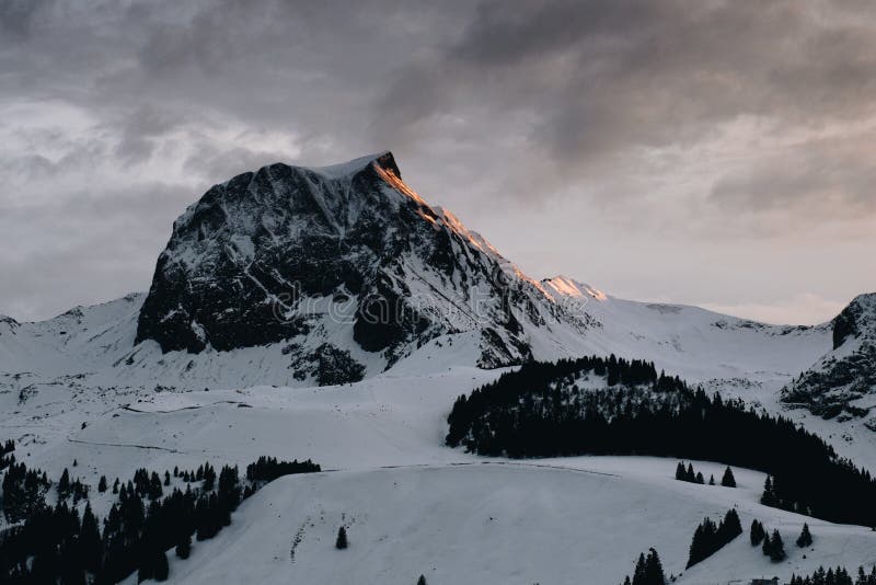 Snowy Mountain Landscape Against the Bright Cloudy Sky Stock Photo ...