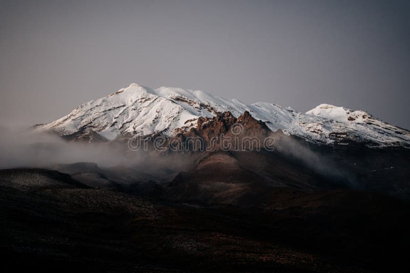 Snowy Mountain Peak on a Cloudy Day Stock Photo - Image of cold, smoke ...