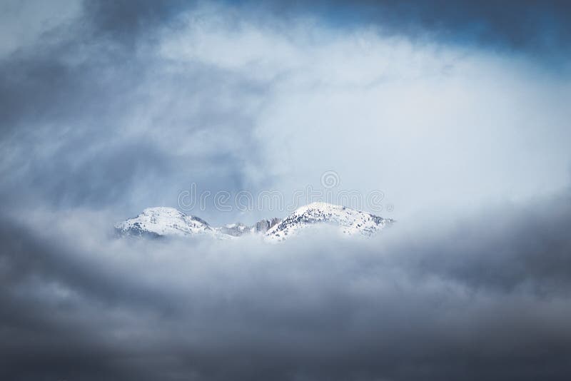 Snowy Mountain Peaks Seen between the Clouds Stock Image - Image of ...
