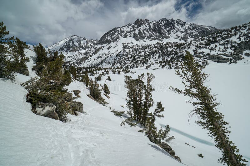 A Snowy Mountain Range with a Lake in the Foreground Stock Photo ...
