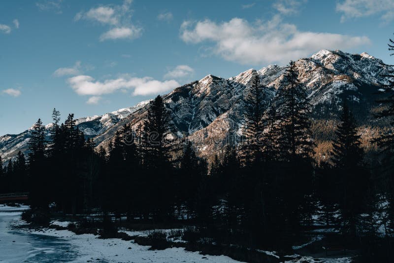 Snowy Mountainside with Frozen Trees and Ice-covered Water. Stock Photo ...