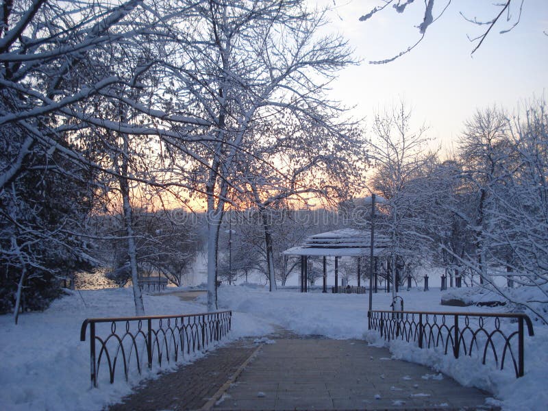 Snowy park at twilight stock image. Image of handrail - 65881207