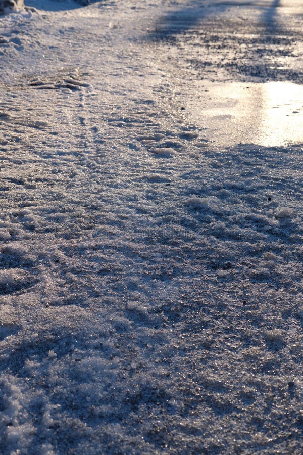 Snowy path in early spring stock photo. Image of reflection - 213787718