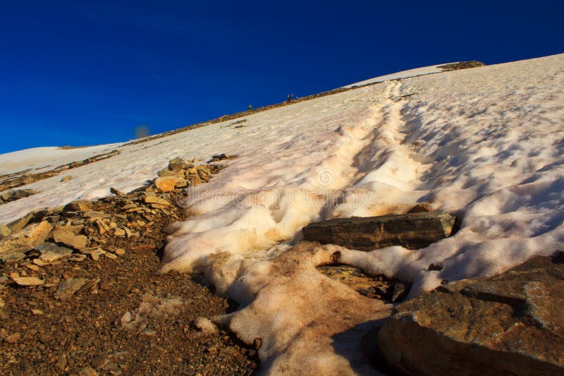 Snowy path on the slope stock photo. Image of formation - 186589926