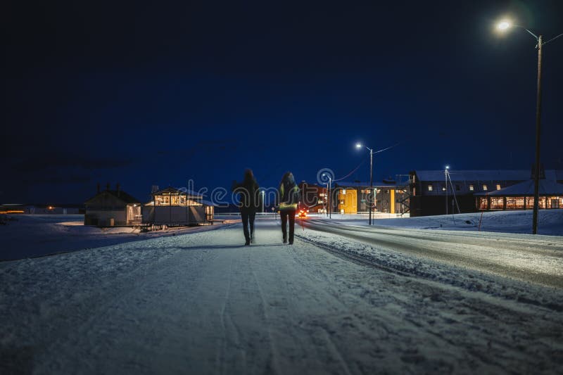 Snowy Pathway with Distant Town Lights in Svalbard Stock Image - Image ...