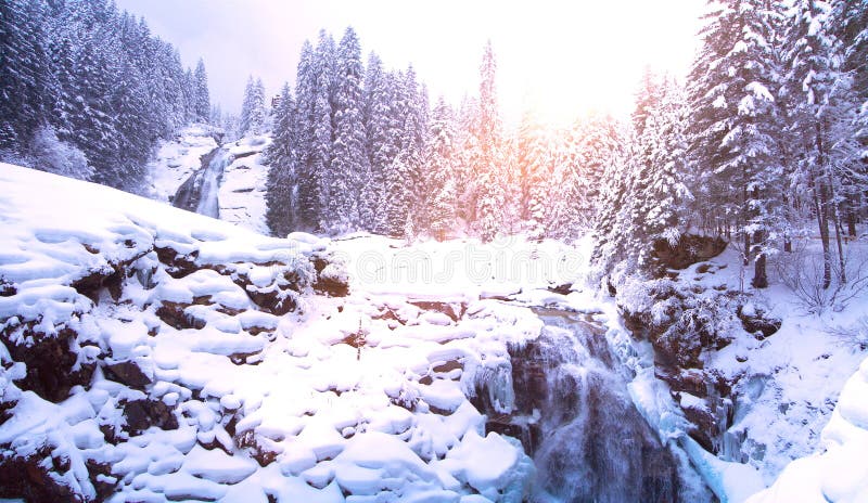 Snowy Waterfall in the Forest with Sun Stock Image - Image of tree ...