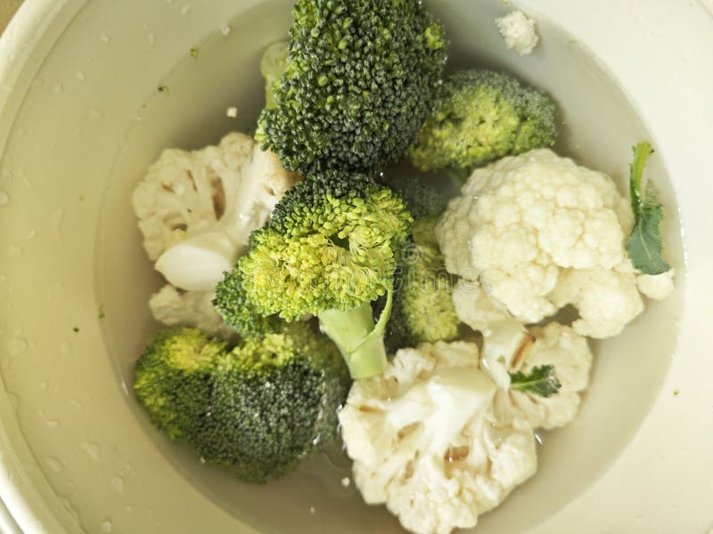 Soaking Small Chucks of White and Green Cauliflower in the Container ...