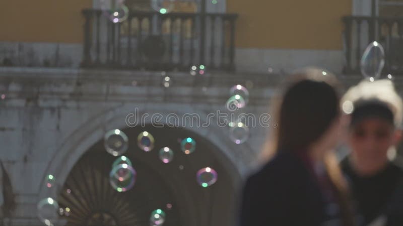 Soap Bubbles Floating in Urban Setting with Blurred People Stock ...