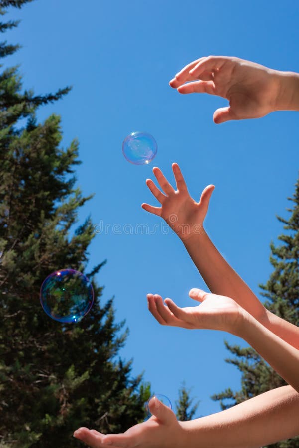 Soap Bubbles in Hands Against a Blue Sky Stock Photo - Image of green ...