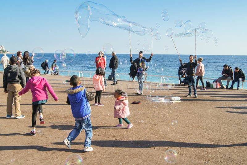 Soap bubbles among people. editorial image. Image of outdoor - 89090425